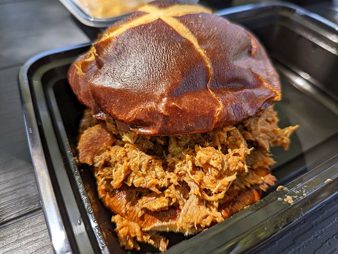 This pulled pork sandwich isn't just lunch &ndash; it's a commitment to excellence piled high on a bun that's brave enough to contain such magnificence.