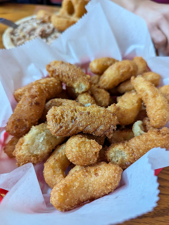 Golden-brown hush puppies that crunch like a promise. These cornmeal treasures are the supporting actors that sometimes steal the whole show.
