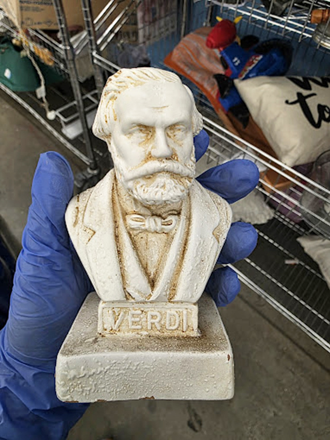 A Verdi bust emerges from the chaos like an operatic surprise. One person's decluttered knickknack becomes another's conversation piece.