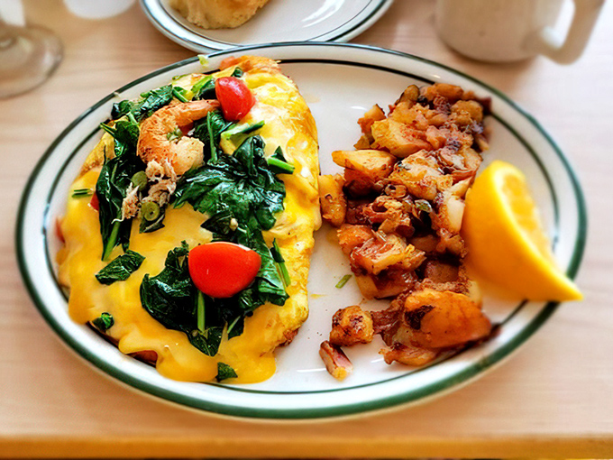 Where grits meet omelet excellence. The side-by-side plating isn't just presentation&mdash;it's a strategy for optimal enjoyment of two breakfast superstars.