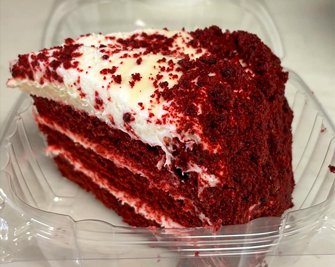 Red velvet cake so vibrant it could stop traffic, layered with cream cheese frosting that strikes the perfect balance between sweet and tangy.
