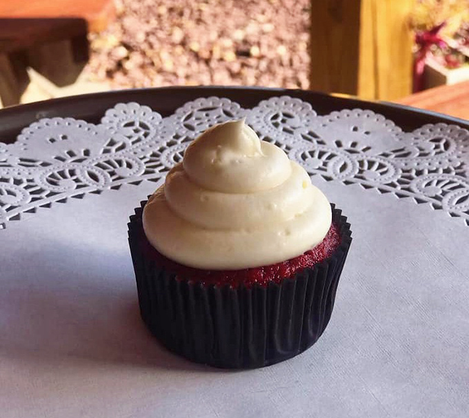 Red velvet cupcake sitting pretty on a doily &ndash; because even tough barbecue joints have a soft spot for proper dessert presentation.