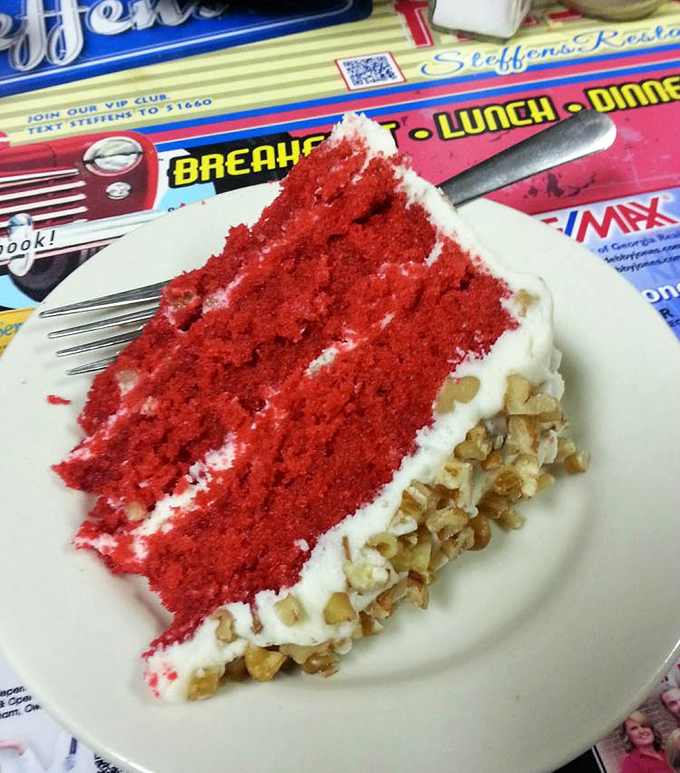 This slice of red velvet cake isn't just dessert; it's a celebration on a plate. The cream cheese frosting and pecan crust make it a Southern classic.