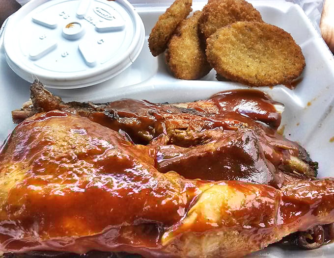 Fried cornmeal hush puppies alongside sauce-slathered chicken&mdash;proof that sometimes the best things in life come in styrofoam containers.