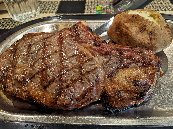 A ribeye that would make vegetarians reconsider their life choices. Perfectly seared and served with a baked potato sidekick.