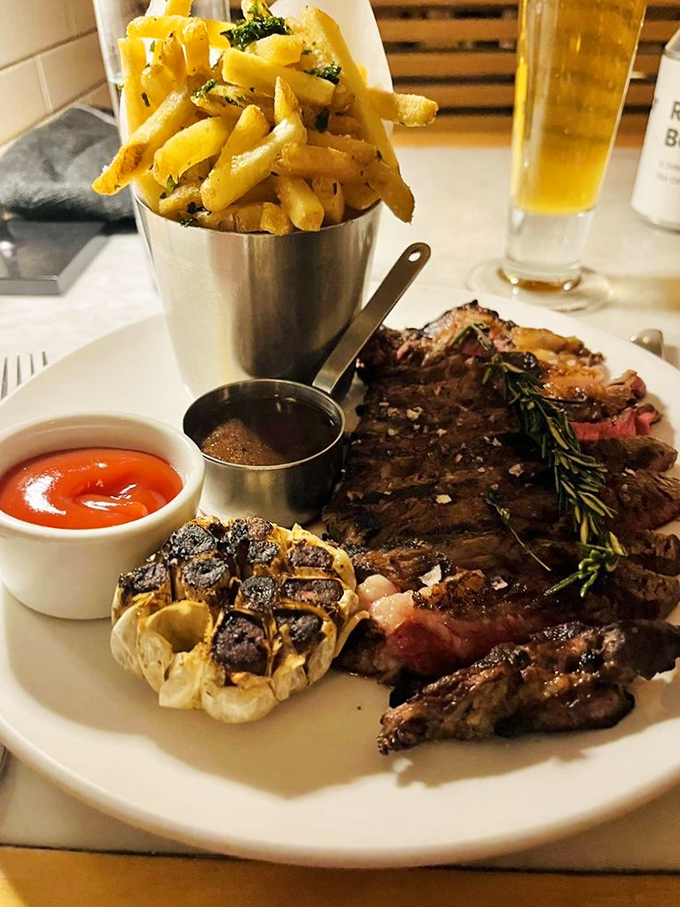 A steak that needs no introduction, accompanied by fries that could easily upstage it. That roasted garlic head is the unsung hero.