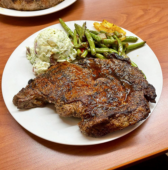 A ribeye that speaks the universal language of "perfectly cooked." Paired with potato salad and green beans, it's comfort food elevated to art form.