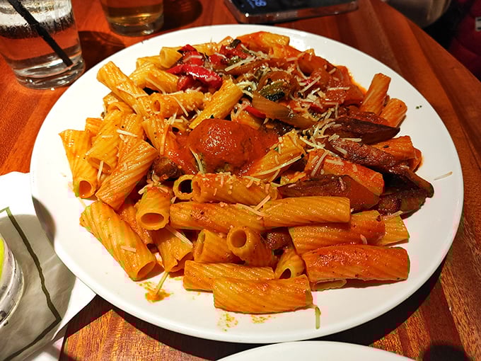 Rigatoni tubes standing at attention, ready to transport that rich, vibrant sauce from plate to palate with military precision.