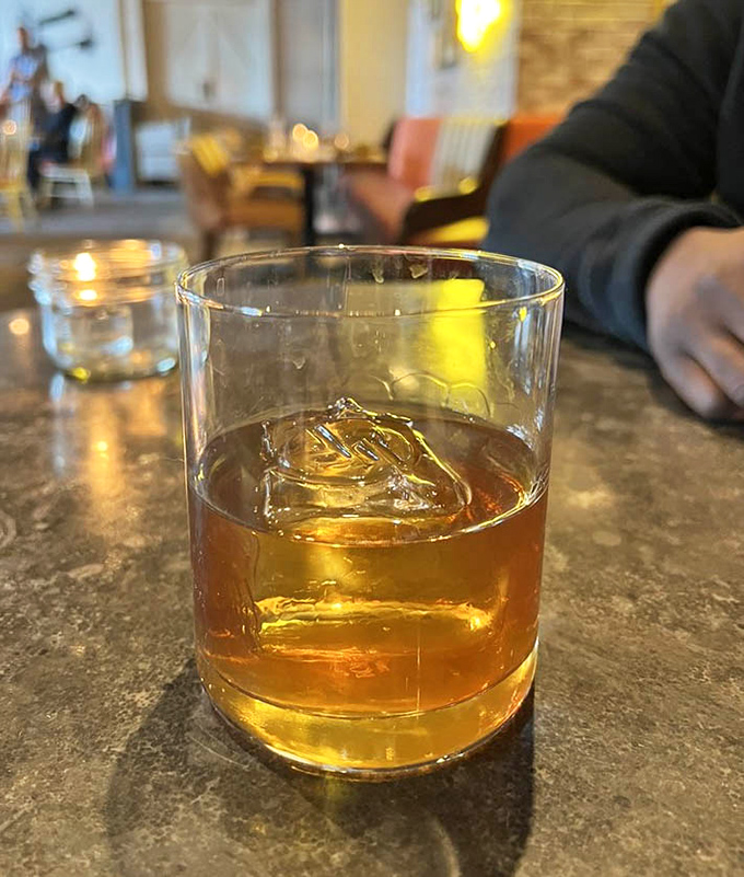 The amber glow of a perfectly crafted whiskey cocktail catches the light, promising complexity that goes far beyond mere alcohol.