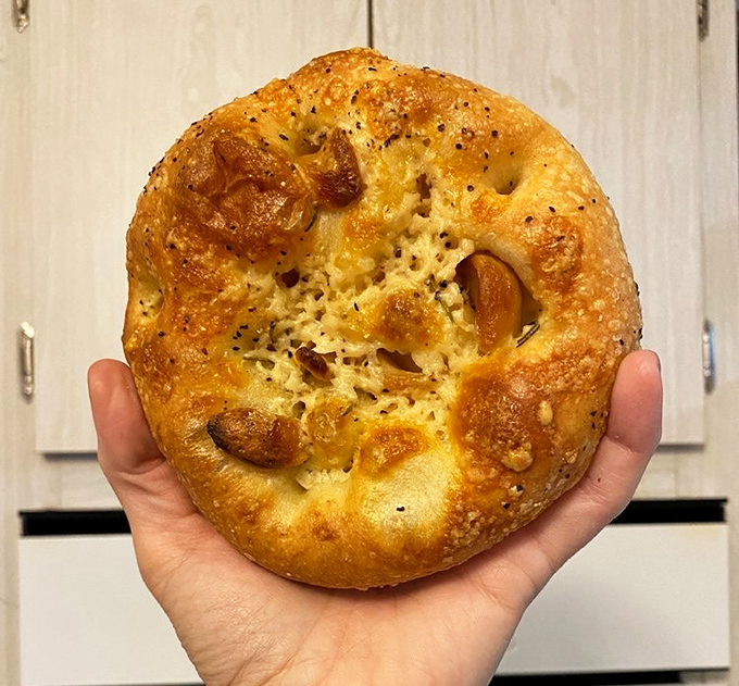 Focaccia that makes Italian grandmothers nod in approval&mdash;dimpled, golden, and studded with roasted garlic that announces itself to everyone you talk to afterward.