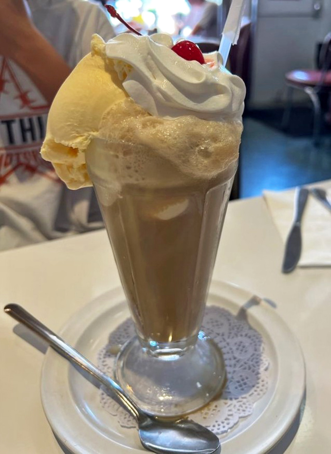 A proper root beer float—where vanilla ice cream slowly surrenders to the soda, creating that magical creamy foam that defines American soda fountain perfection.