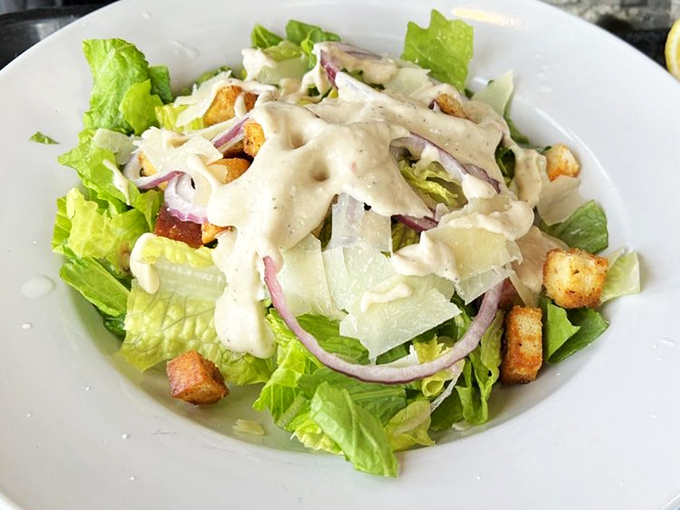 A Caesar salad that knows its role&mdash;crisp romaine, just enough dressing, and croutons that crunch. Sometimes the simplest things require the most restraint.