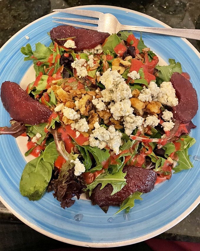 A salad that transforms simple greens into something spectacular with roasted beets, walnuts, and crumbled cheese.