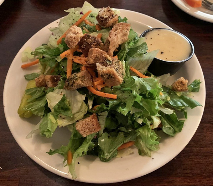 A salad that doesn't apologize for being a salad. Fresh greens and house-made dressing prove vegetables can hold their own at a steakhouse&mdash;they just need proper introduction.