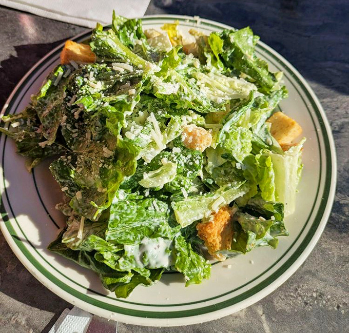 A Caesar salad that doesn't apologize for being a salad &ndash; crisp, bright, and assertive enough to hold its own on a menu of comfort classics.