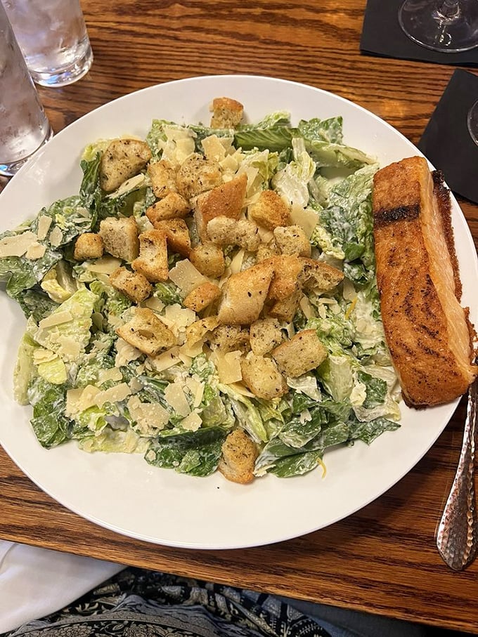 This Caesar salad isn't just playing a supporting role &ndash; it's staging a delicious rebellion with crisp romaine and golden garlic bread.
