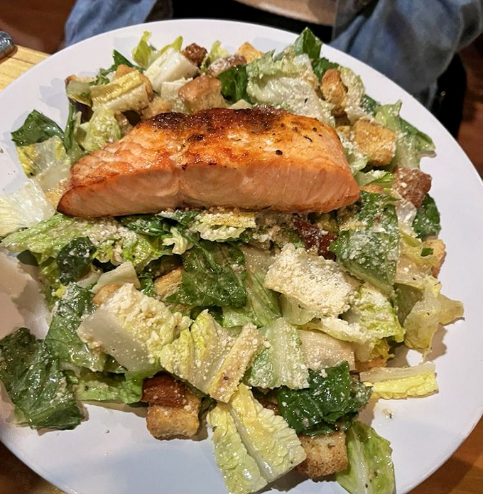 Salmon that could convert a carnivore. Perched atop a Caesar salad like it's holding court, the crispy skin practically winks at you.