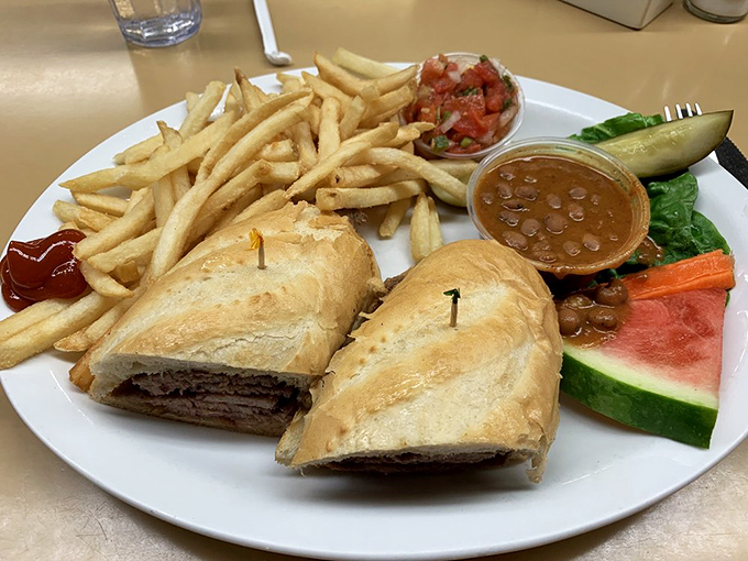 A sandwich that understands the importance of proper bread-to-filling ratio, served with fries that clearly graduated with honors from potato university.