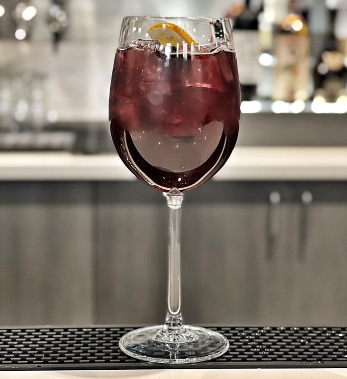 A sangria that's dressed better than most people at dinner. That citrus garnish isn't just pretty &ndash; it's plotting to make your evening memorable.