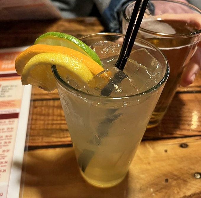 A refreshing cocktail garnished with citrus slices &ndash; because sometimes you need something bright and zippy to cut through all that glorious cheese.