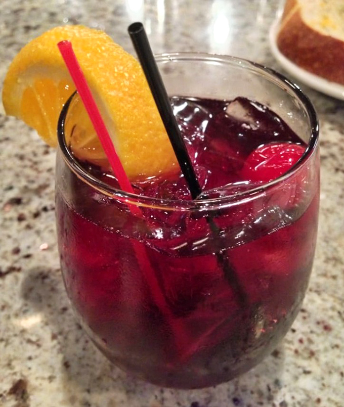 A ruby-red sangria garnished with orange&mdash;because sometimes watching boats bob in the harbor requires a drink as pretty as the view.