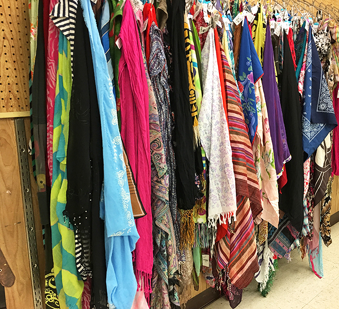 A kaleidoscope of scarves dangles like colorful promises. Each one whispers tales of past adventures and offers new style possibilities.
