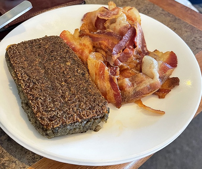 Delaware's beloved scrapple makes its appearance alongside crispy bacon. A breakfast duo that separates the tourists from the locals.