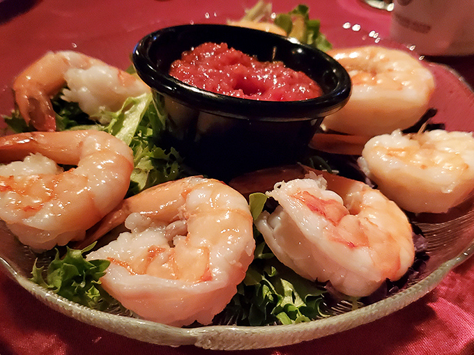 These aren't just shrimp; they're ambassadors of the sea, perfectly poised around their cocktail sauce companion like synchronized swimmers taking a bow.