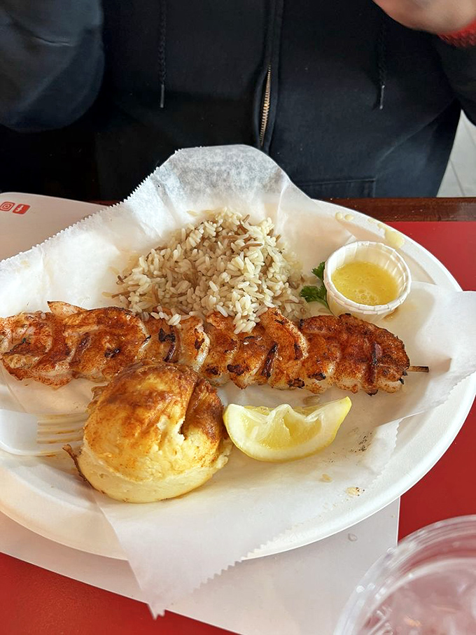 Skewered shrimp that's been kissed by fire, served with rice and that signature potato. A plate that proves simplicity is the ultimate sophistication.