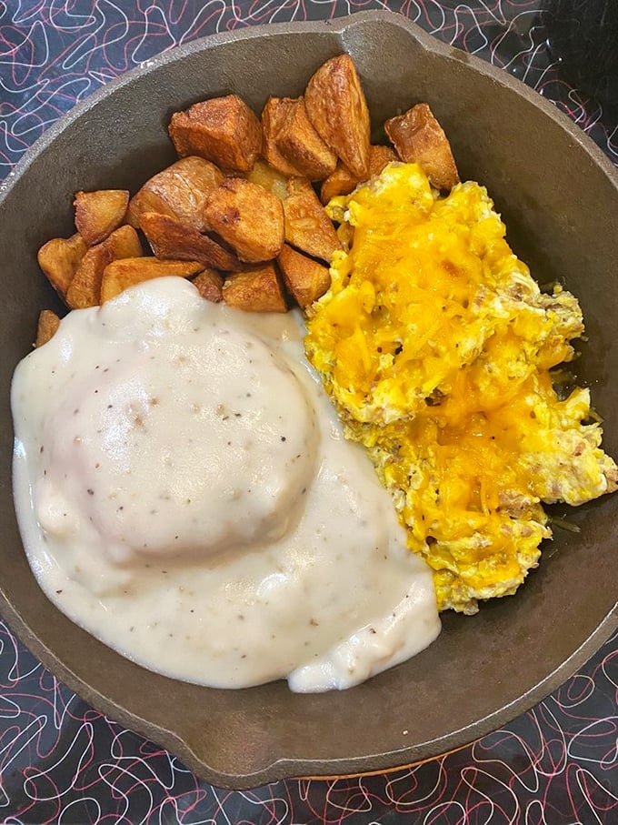 Breakfast skillet perfection: golden potatoes, melted cheese, and eggs that remind you why morning meals deserve all-day status on any respectable menu.