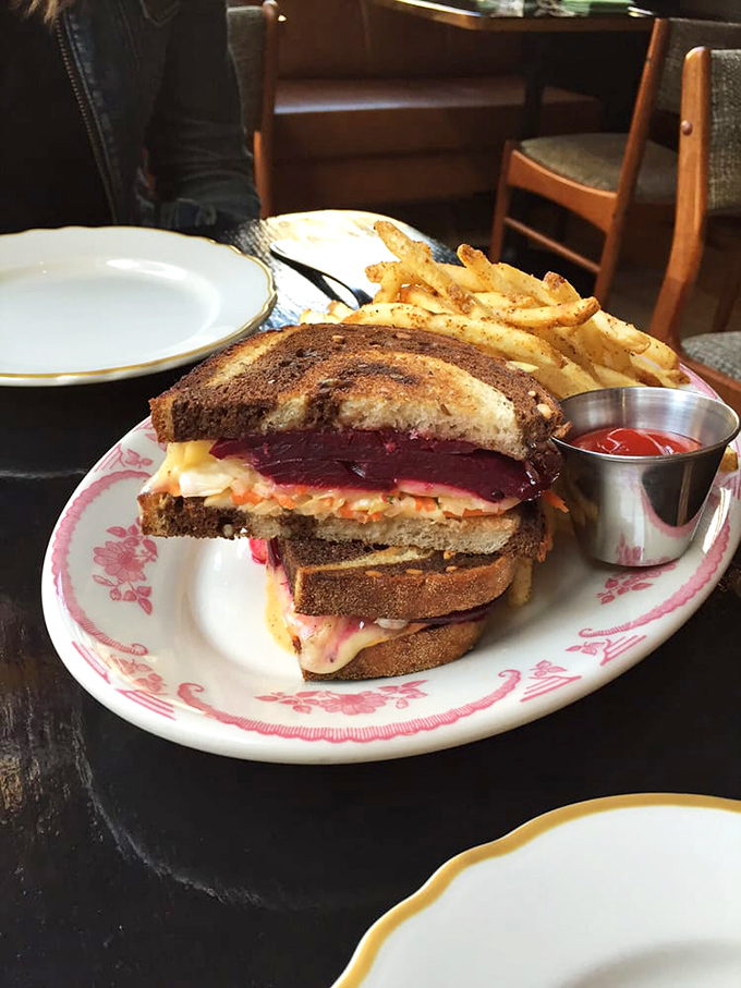 A sandwich that demands to be photographed before eaten, with layers that tell a delicious story between perfectly griddled bread.