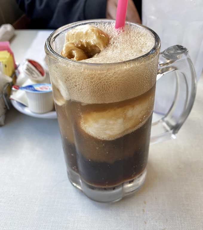 This root beer float isn't just a drink&mdash;it's a frothy tower of childhood memories topped with ice cream that's making a grand entrance.