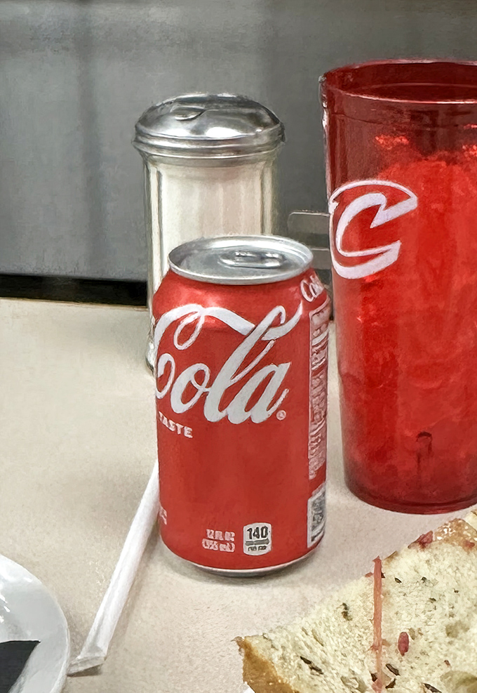 Classic beverages complete the deli experience. Nothing cuts through the richness of a towering sandwich quite like an ice-cold soda in that iconic red can.