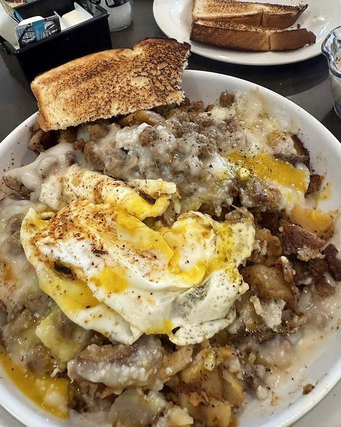 When breakfast can't decide what it wants to be, so it becomes everything. This glorious mess of eggs, potatoes, and gravy is comfort food wearing its Sunday best.