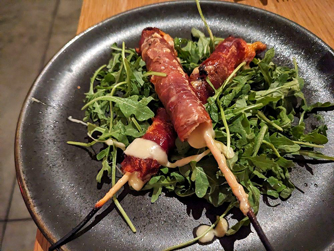 Spiedini&mdash;Italian for "why have we been eating cheese sticks wrong our entire lives?" Prosciutto-wrapped fontina on a bed of peppery arugula.