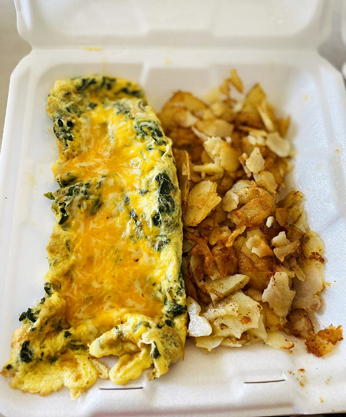 An omelet that's had a passionate affair with spinach and cheese, resulting in a fluffy yellow creation that's worth getting out of bed for.