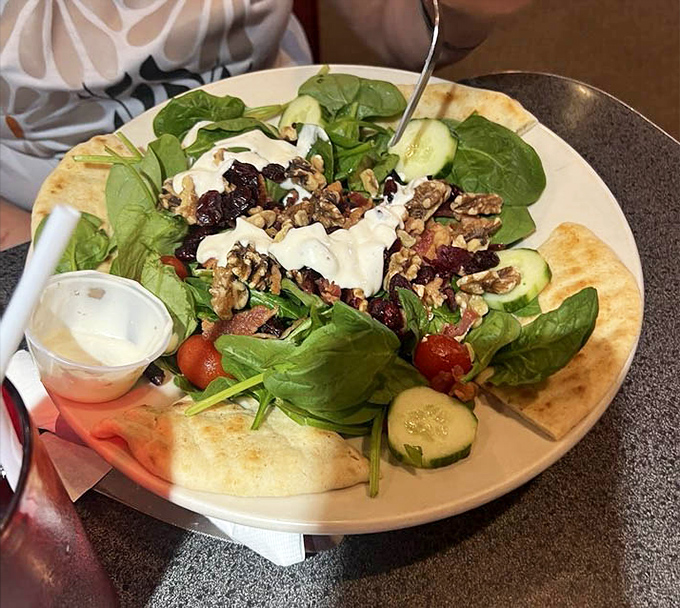 A garden on a plate&mdash;this spinach salad proves diners can do fresh and vibrant alongside their comfort food classics.