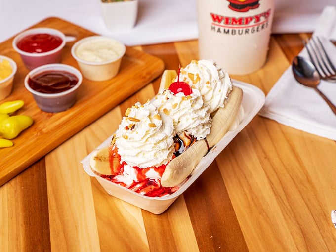 This banana split isn't just dessert &ndash; it's a childhood memory served in a boat with whipped cream mountains and cherry-topped nostalgia.