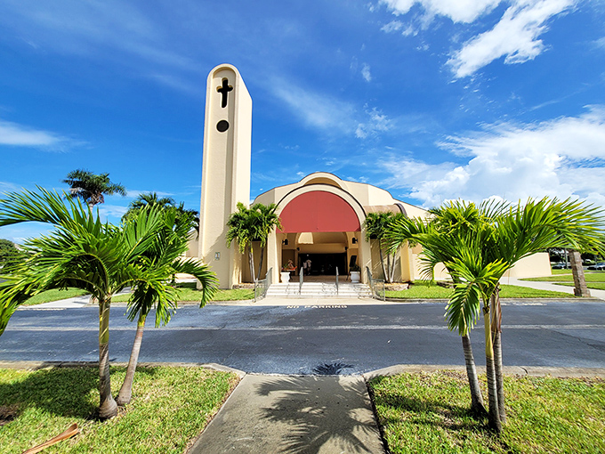 St. Sebastian Catholic Church reaches skyward with architectural flair, its distinctive tower standing like a spiritual lighthouse amid a sea of palm trees.