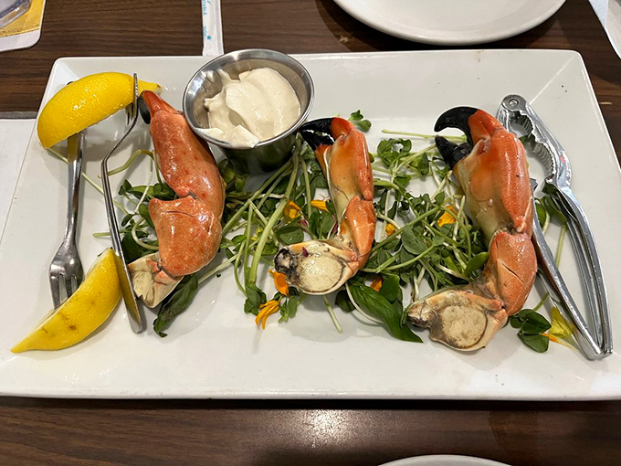 Stone crab claws presented like oceanic jewelry on a bed of microgreens &ndash; Florida's seasonal treasure worth every delicious effort.
