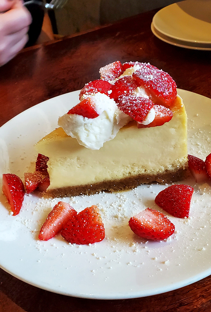 Strawberry cheesecake that looks like it belongs in a magazine spread &ndash; dessert photography at its most tempting peak.
