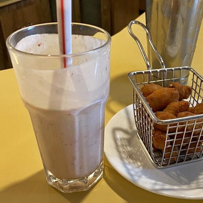 This strawberry shake isn't just a beverage, it's a time machine to simpler days when happiness came in a tall glass with a cherry on top.