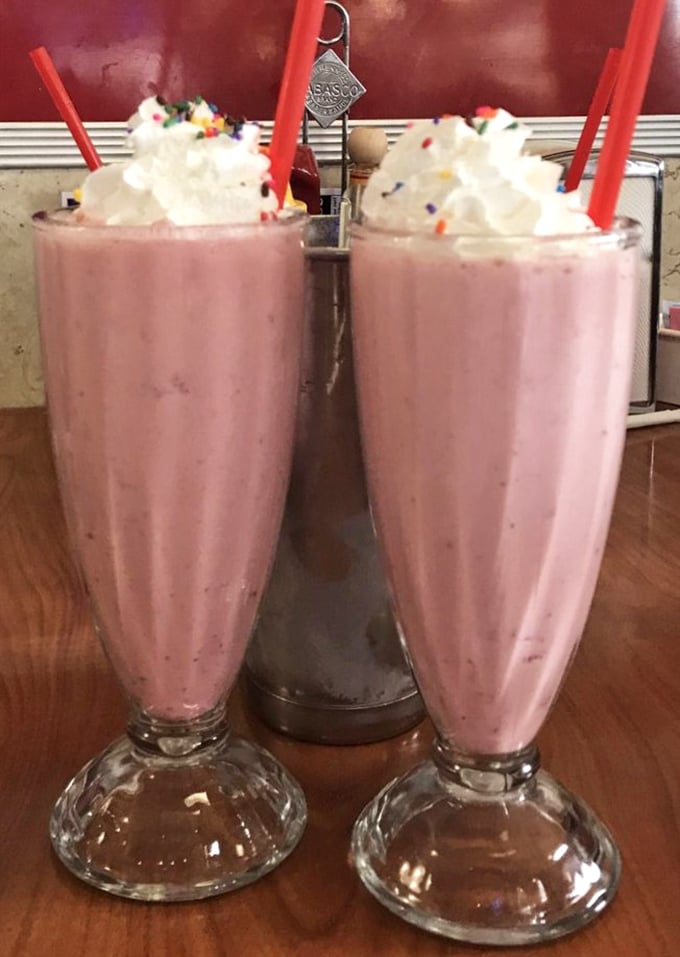 Twin strawberry shakes topped with whipped cream &ndash; proof that sometimes the best things in life come in pairs.