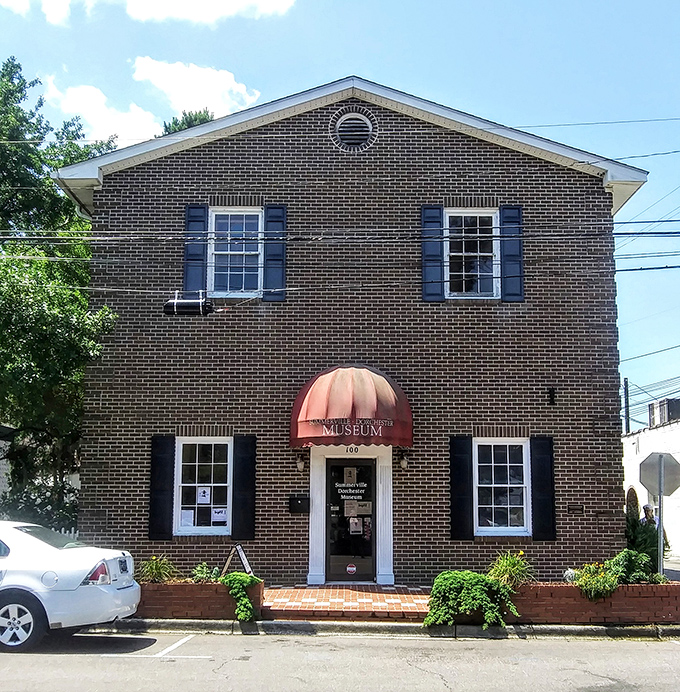 The Summerville Museum stands like a dignified Southern gentleman, brick facade and all, quietly holding the town's stories behind its shuttered windows.