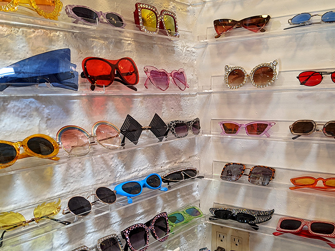 Sunglasses from every era line lucite shelves&mdash;from Jackie O classics to Elton John spectaculars, each pair waiting for its next adventure.