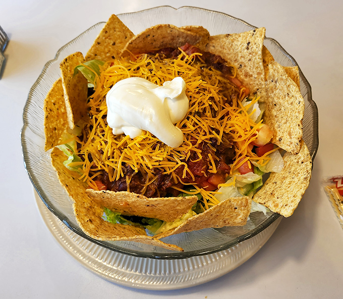 This taco salad bowl isn't just food &ndash; it's edible architecture. A crunchy tortilla fortress protecting seasoned beef, cheese, and veggies from the outside world until you demolish it.