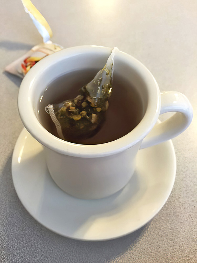 A proper cup of hot tea served in a sturdy white mug&mdash;civilization's most underrated morning ritual.