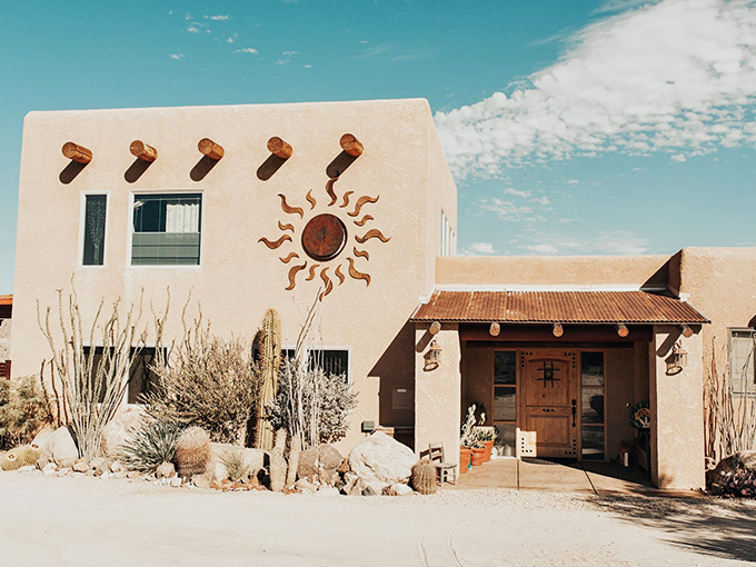 Desert architecture at its finest: adobe walls, wooden beams, and that iconic sun symbol &ndash; Mother Nature's thermostat built right into the design.