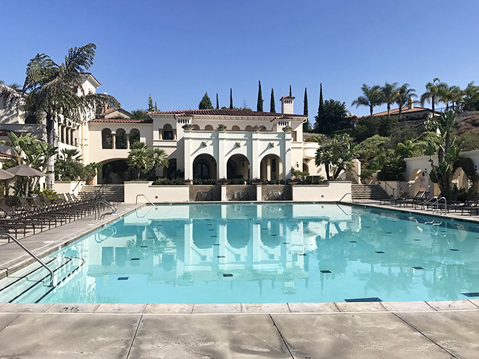 The Woods Clubhouse pool area looks like it was plucked from a Mediterranean resort brochure. Retirement never looked so refreshingly blue.