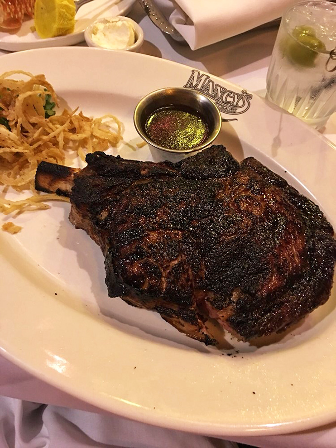 The tomahawk ribeye arrives like a prehistoric masterpiece, proving that bigger really can mean better sometimes.